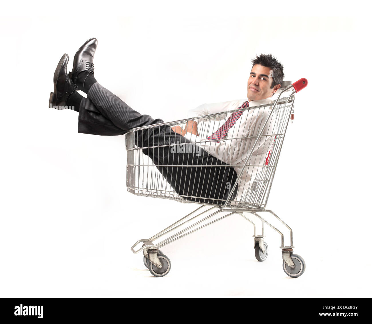 Office worker lying in a shopping cart Stock Photo - Alamy