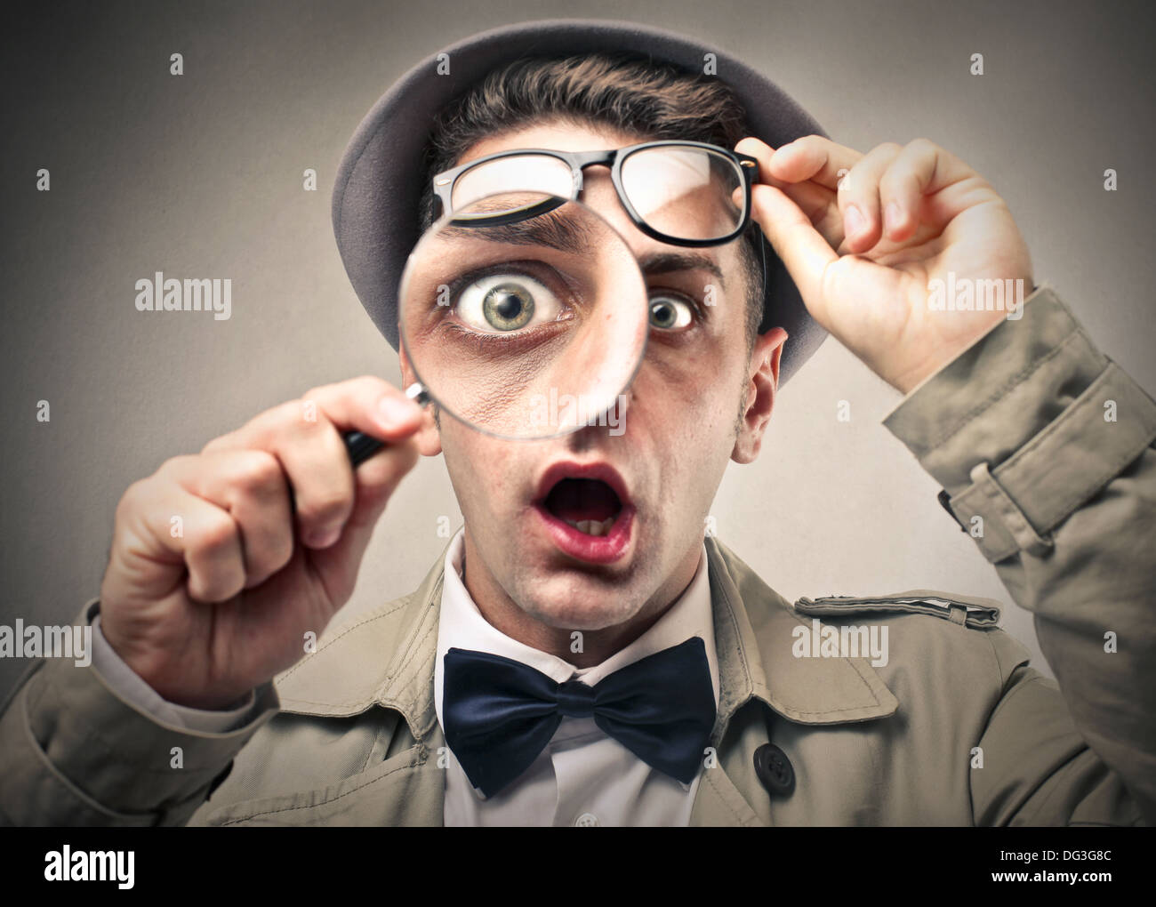 Young detective using a magnifying glass Stock Photo - Alamy