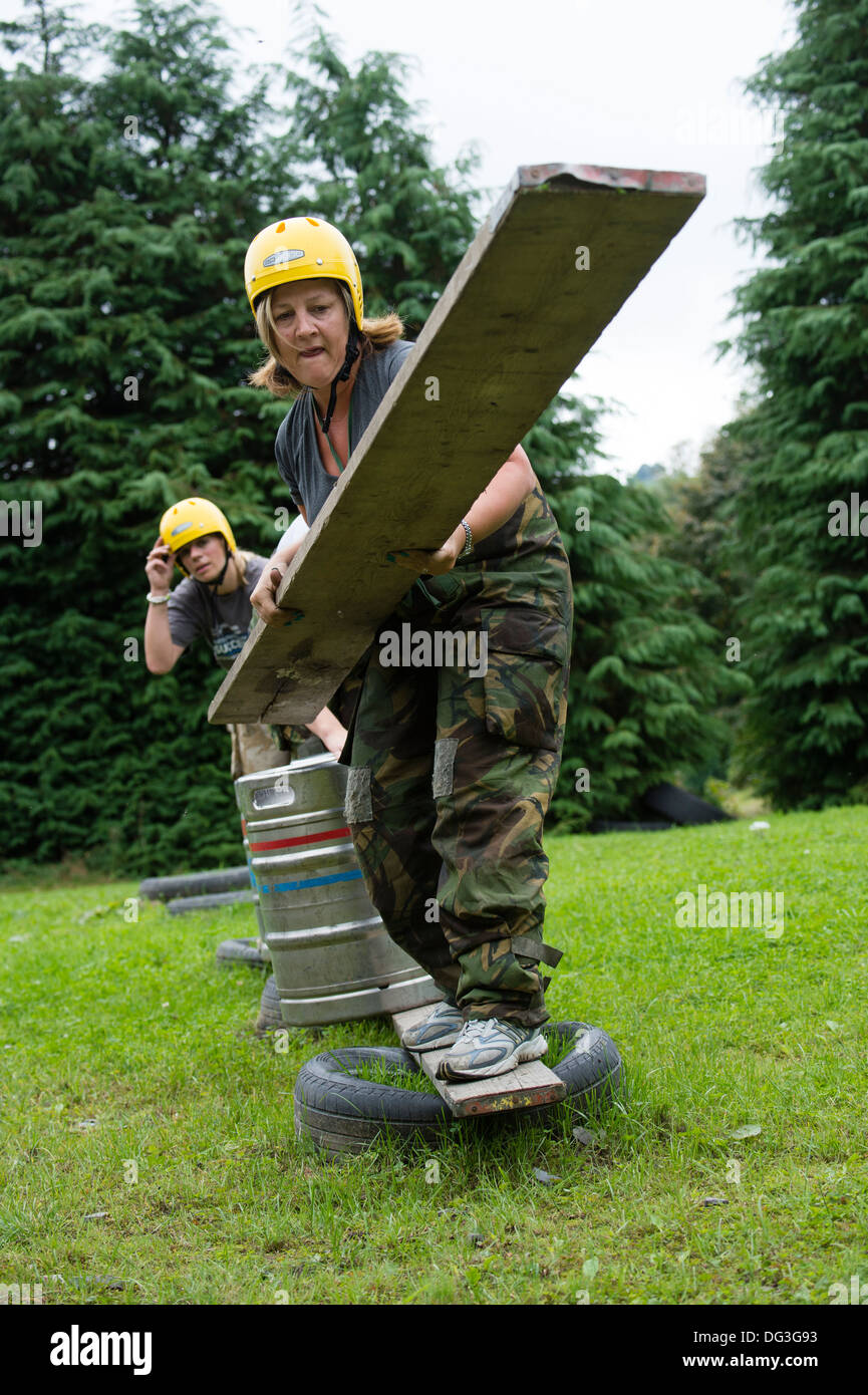 A group of adult women on a team building teambuilding exercise problem ...
