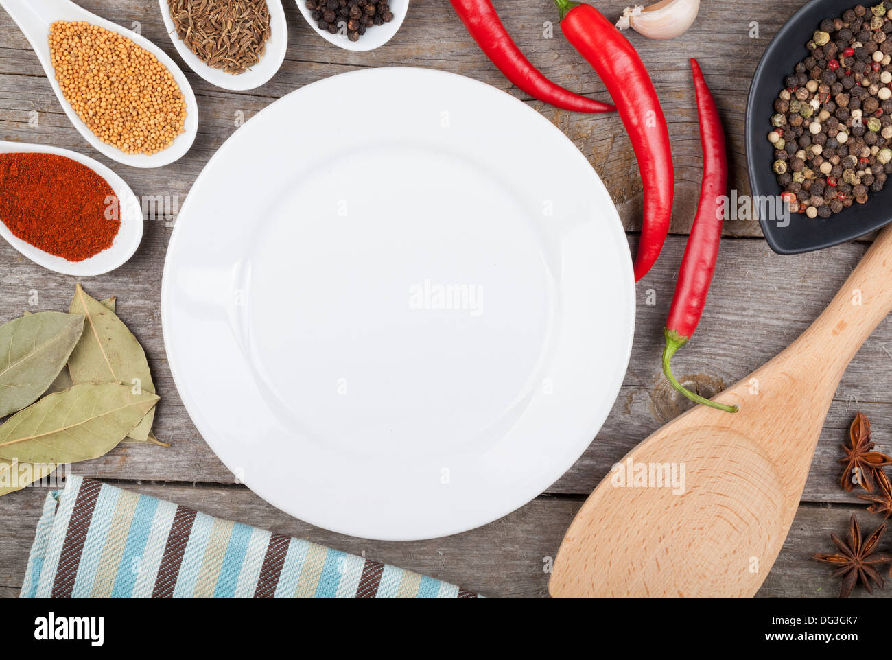 Colorful herbs and spices selection. Aromatic ingredients on wood table ...