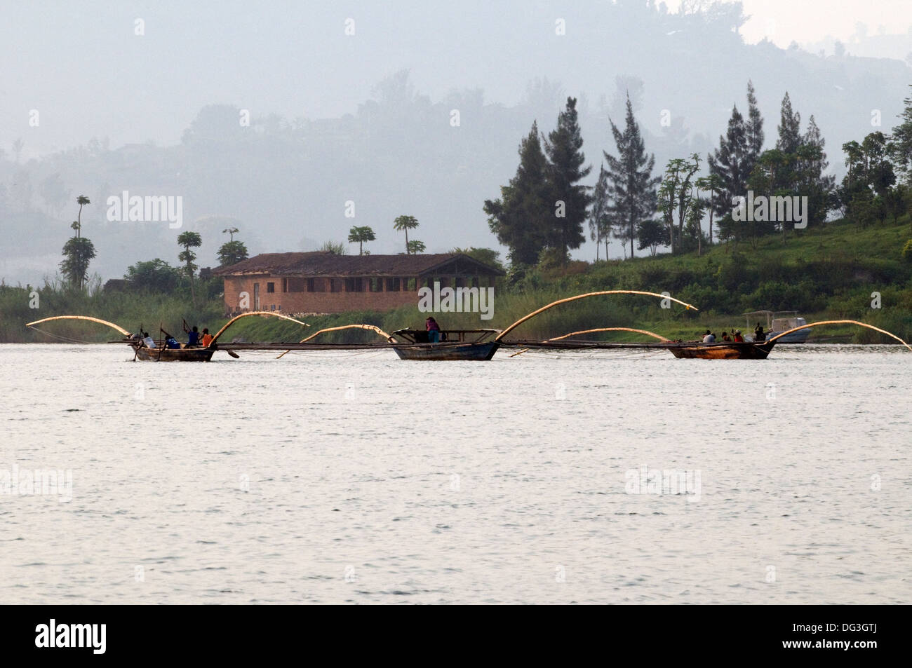 Flotilla of fishing boats working together with extended poles trawling ...