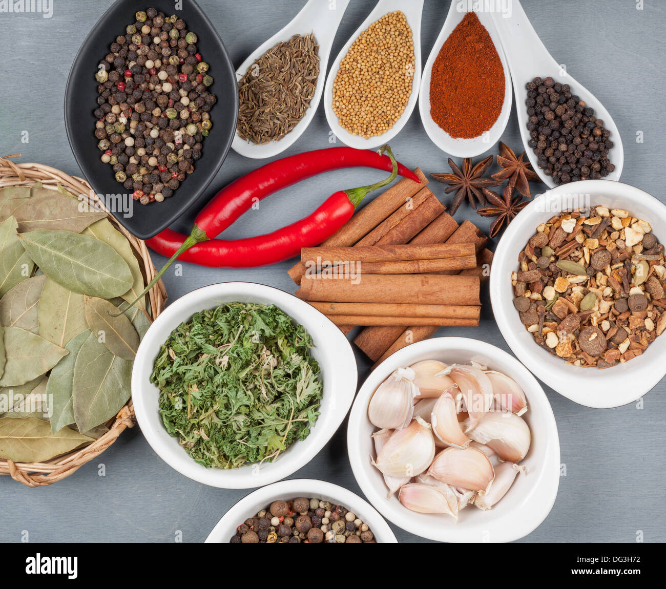 Colorful herbs and spices selection. Aromatic ingredients on wood table ...