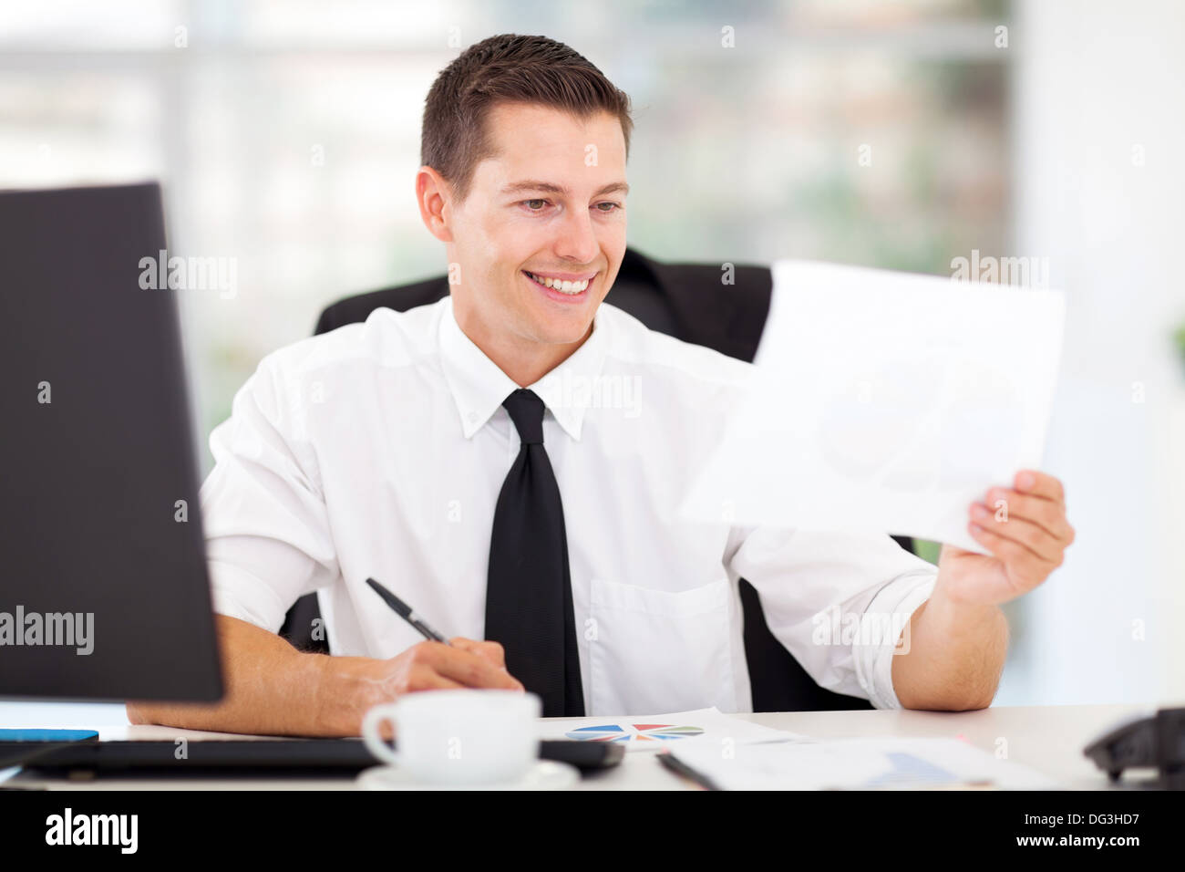 happy businessman writing report in his office Stock Photo - Alamy