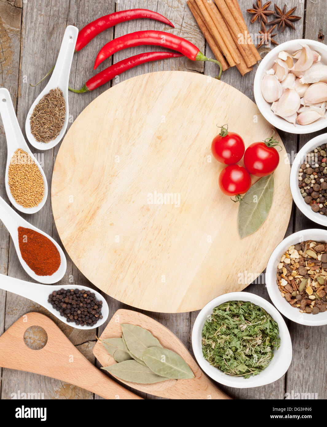 Herbs and spices on wood table background with blank cutting board for ...