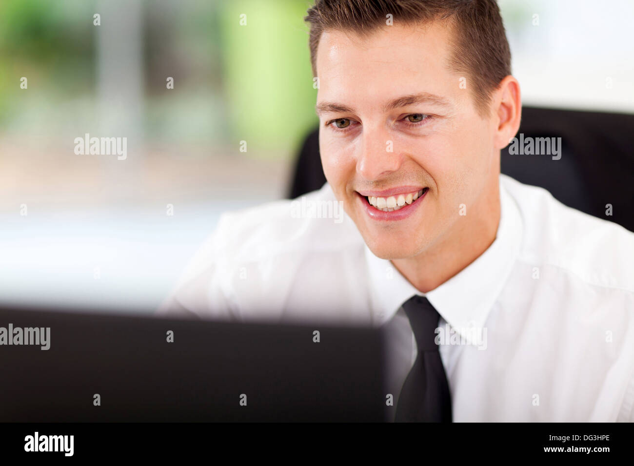 handsome businessman looking at computer screen at workplace Stock ...