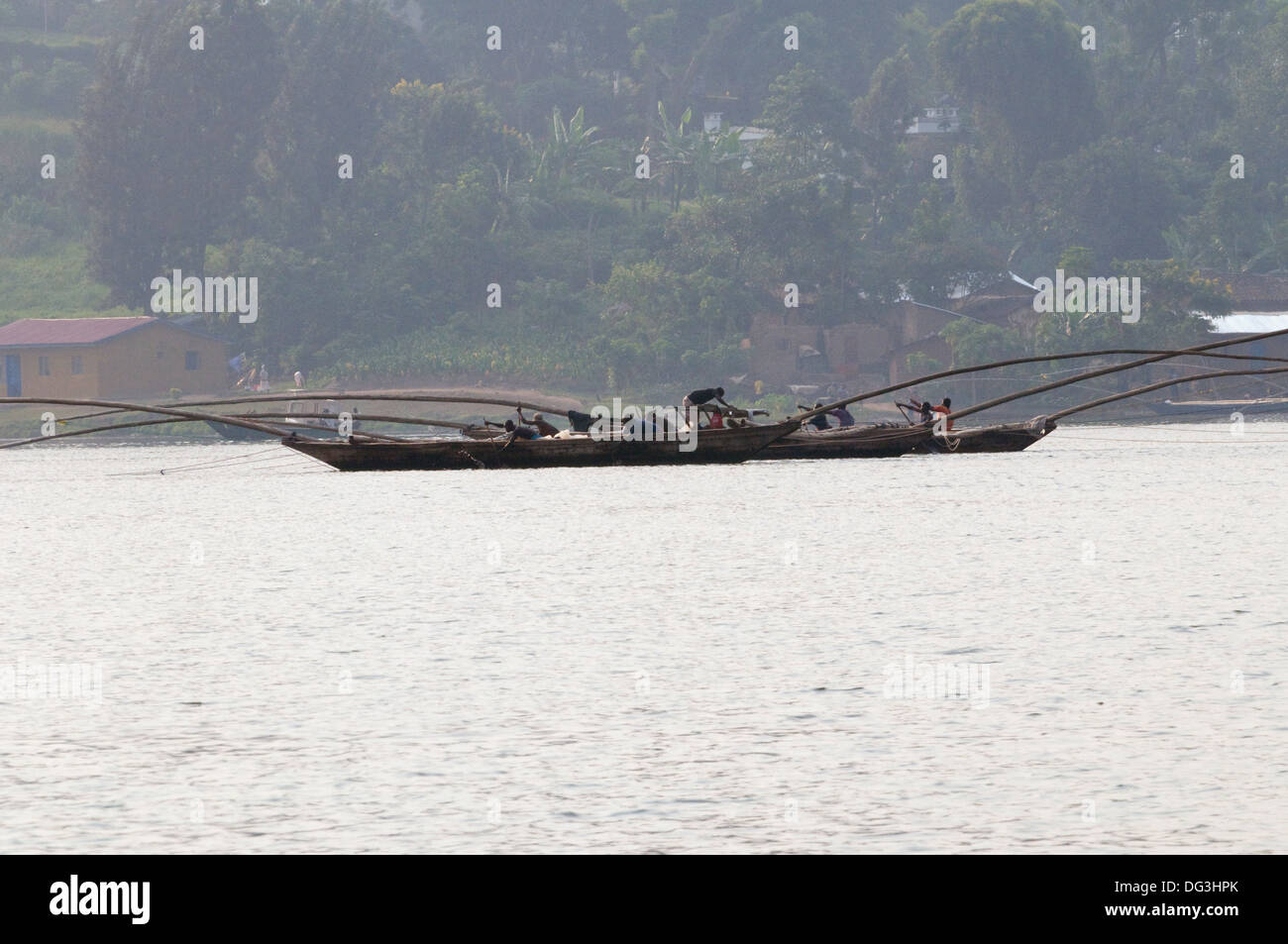 Flotilla of fishing boats working together with extended poles trawling ...