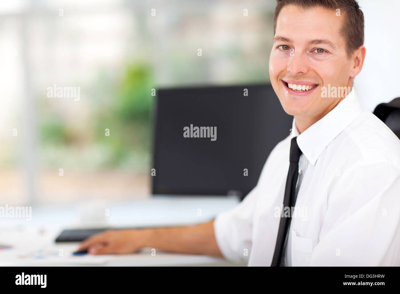 portrait of businessman sitting at office desk Stock Photo - Alamy