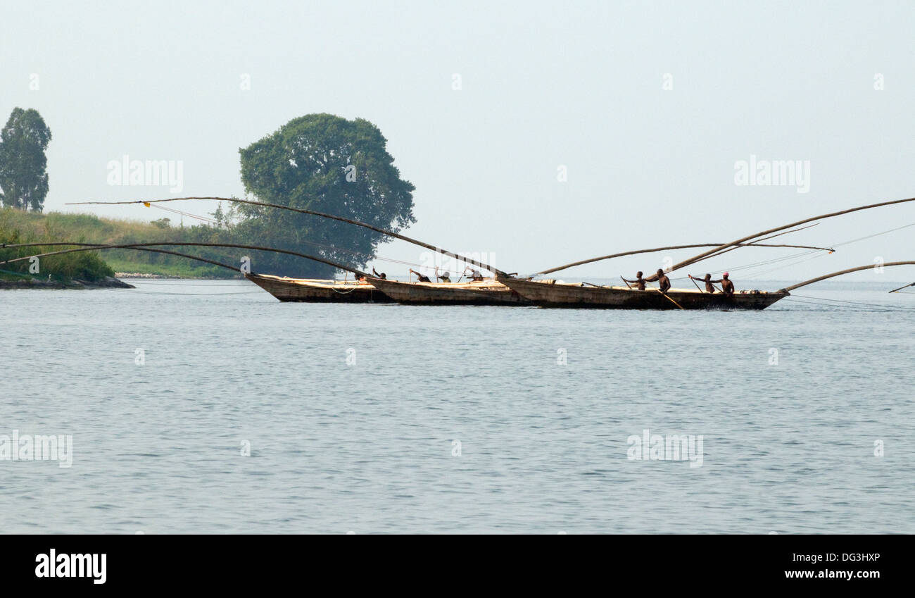 Flotilla of fishing boats working together with extended poles trawling ...
