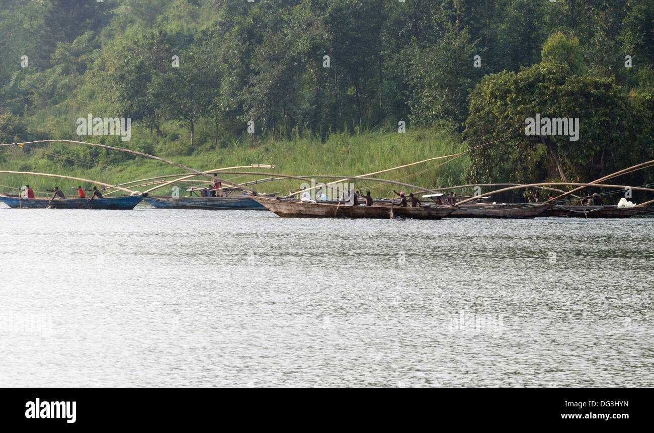 Flotilla of fishing boats working together with extended poles trawling ...
