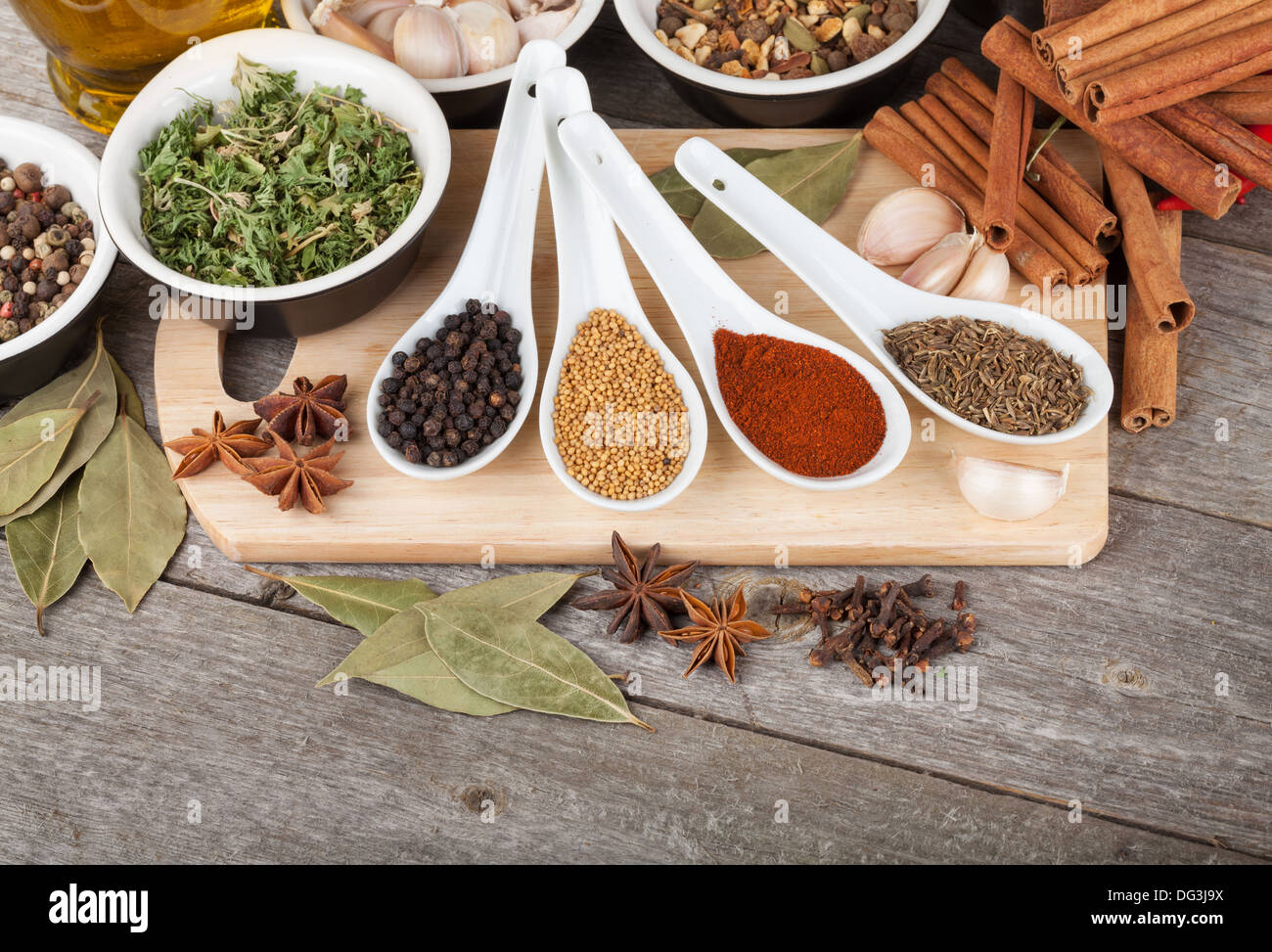 Colorful herbs and spices selection. Aromatic ingredients on wood table ...