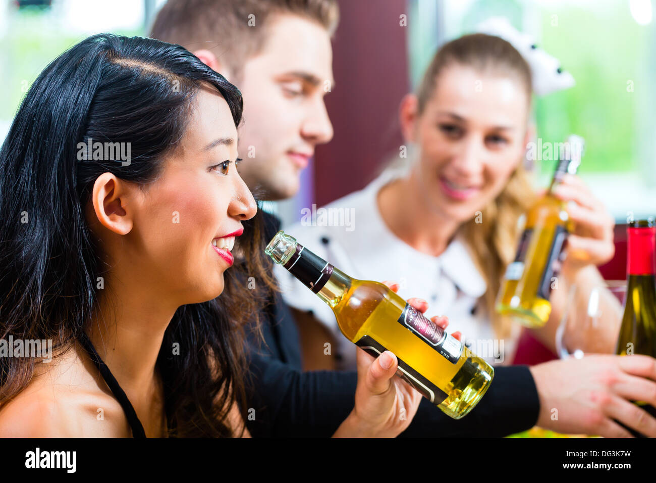 Friends or couples eating fast food and drinking beer in a American ...