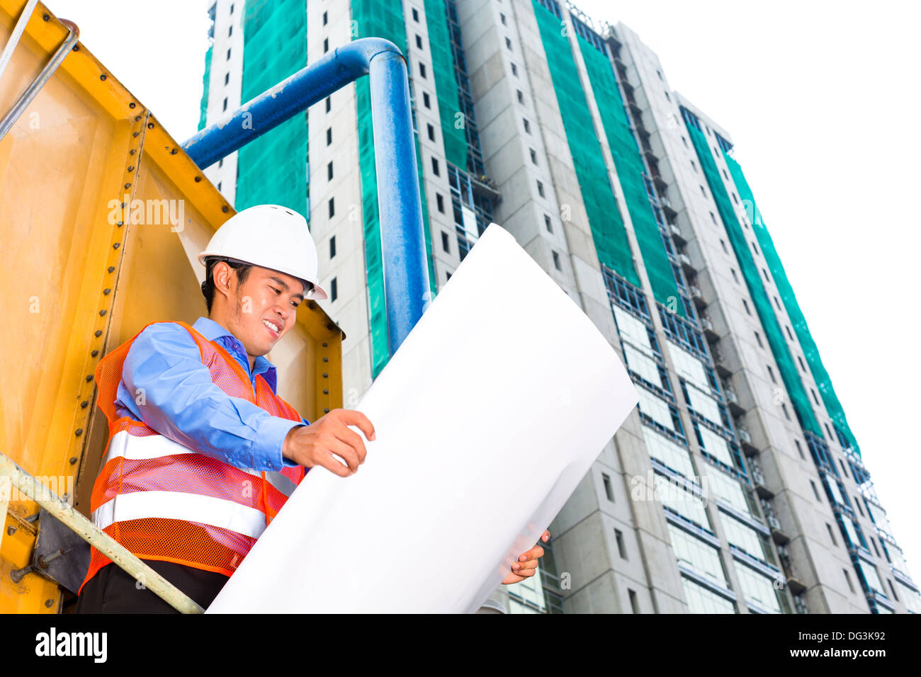 Chinese construction worker or supervisor or architect with clipboard ...