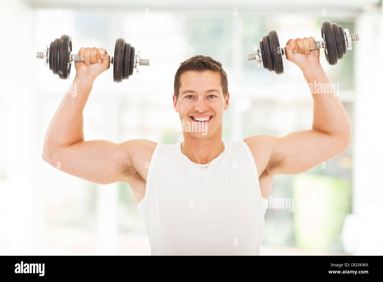 healthy young man lifting two dumbbells Stock Photo - Alamy