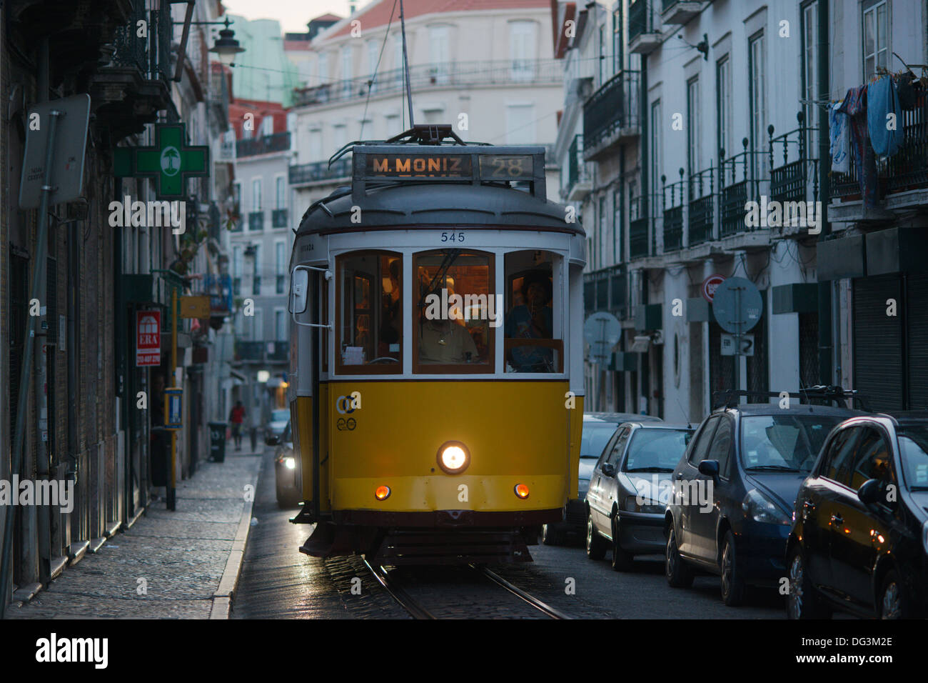 Lisbon's traditional yellow tram on the 28 line, passing at Calçada do ...