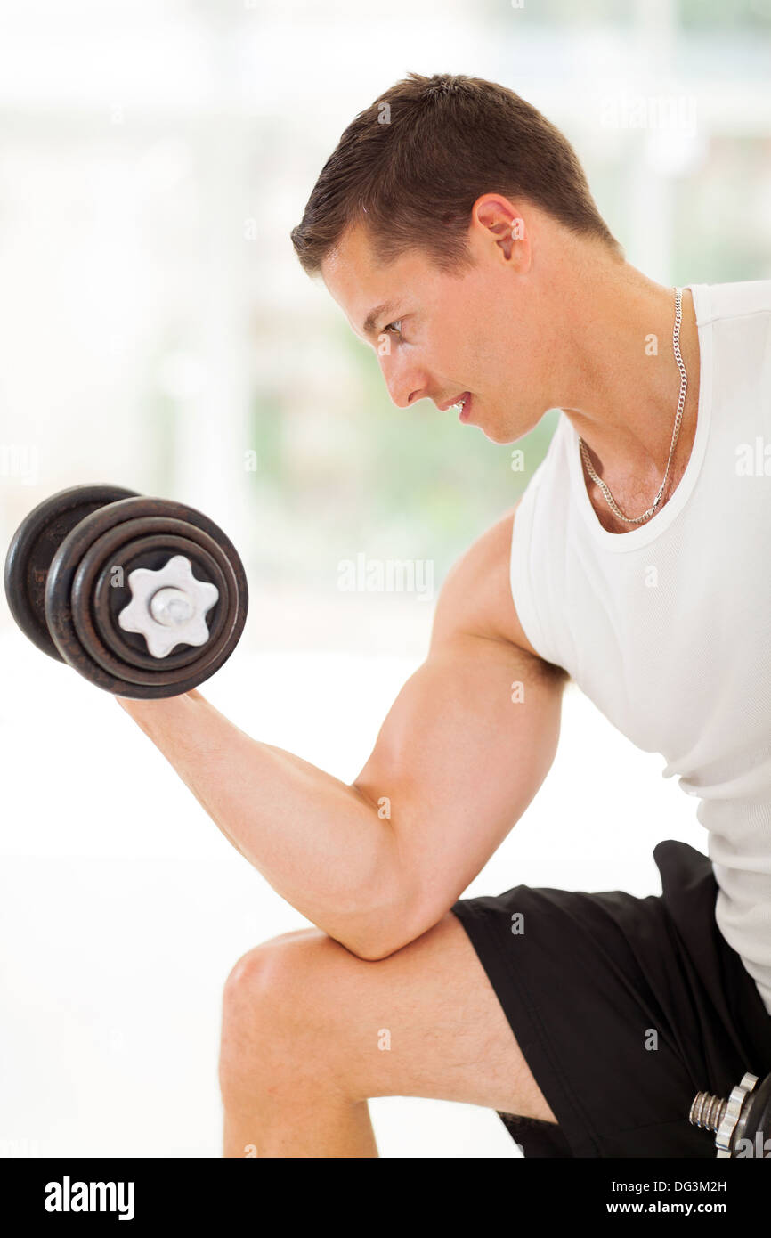 healthy young athlete lifting weights in the gym Stock Photo - Alamy