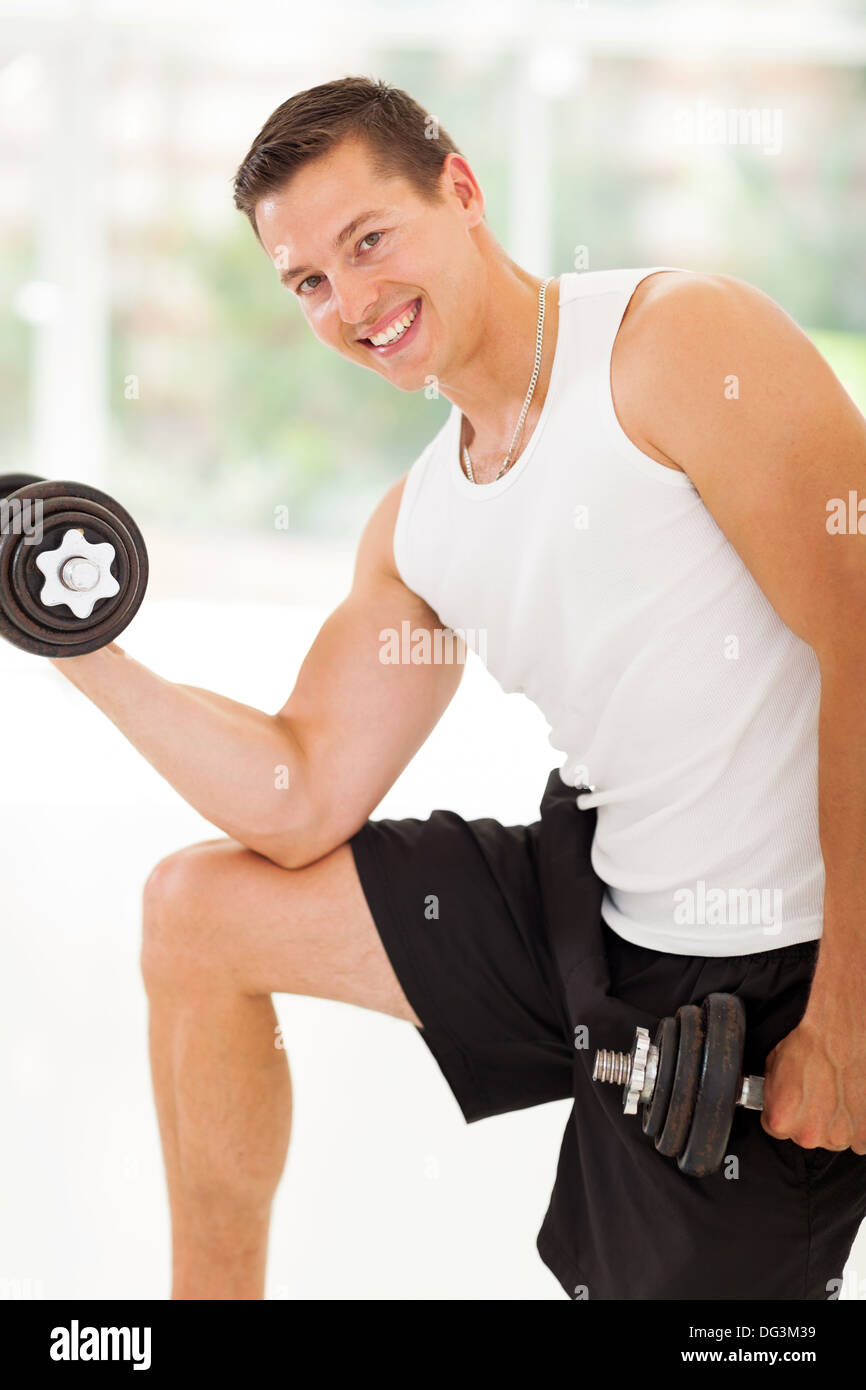 attractive muscular man lifting weights Stock Photo - Alamy