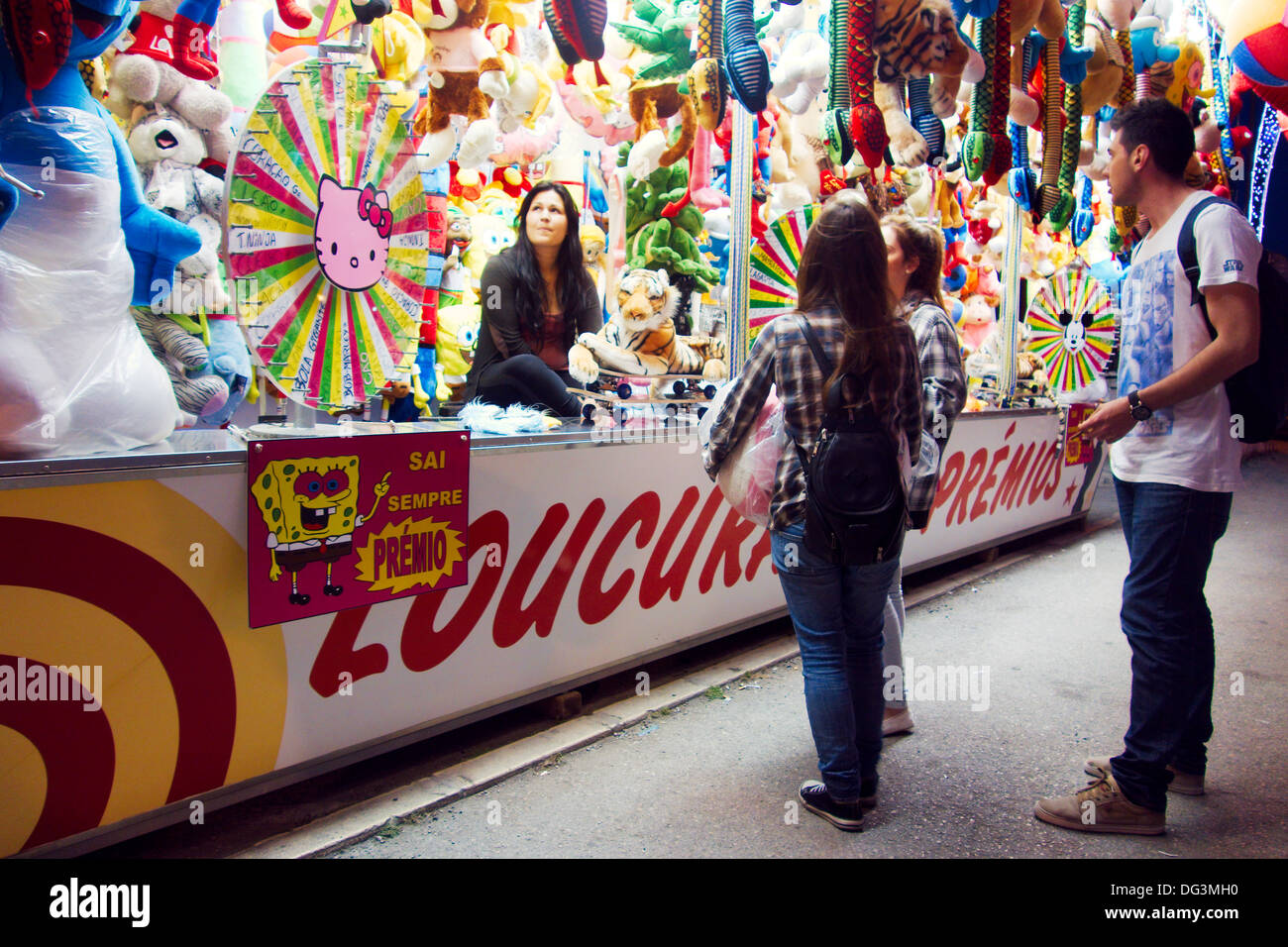 people playing at a fair games trailer Stock Photo - Alamy