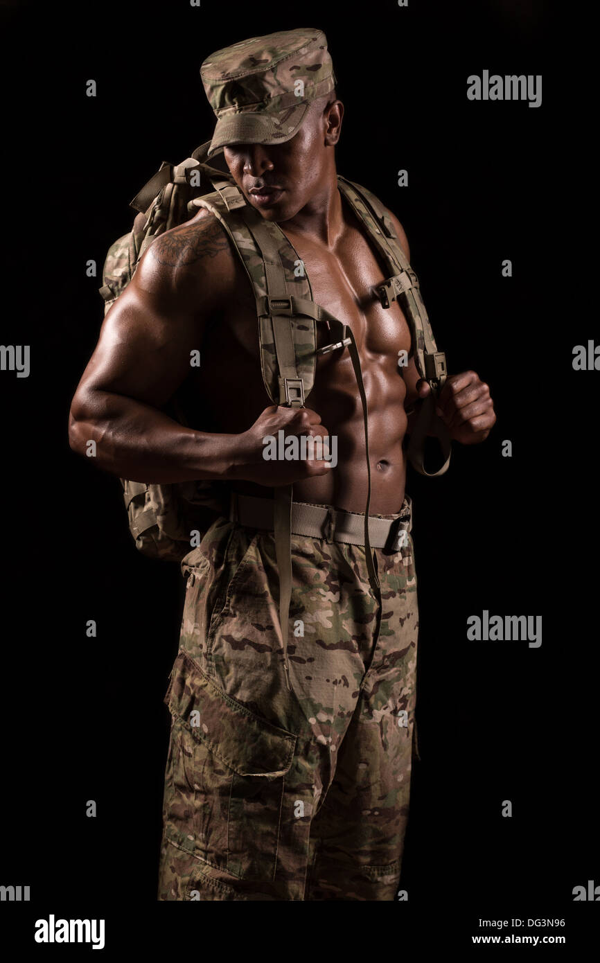 An African American fitness model in camouflage dressed as a soldier ...