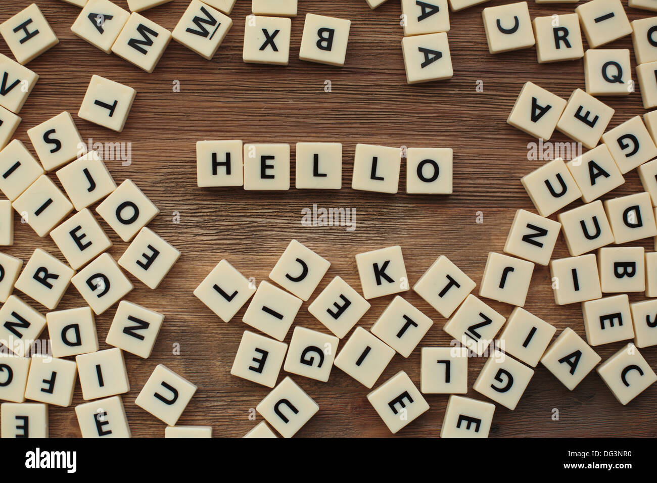 Plastic letters from a childrens' spelling game on a wooden table spell ...