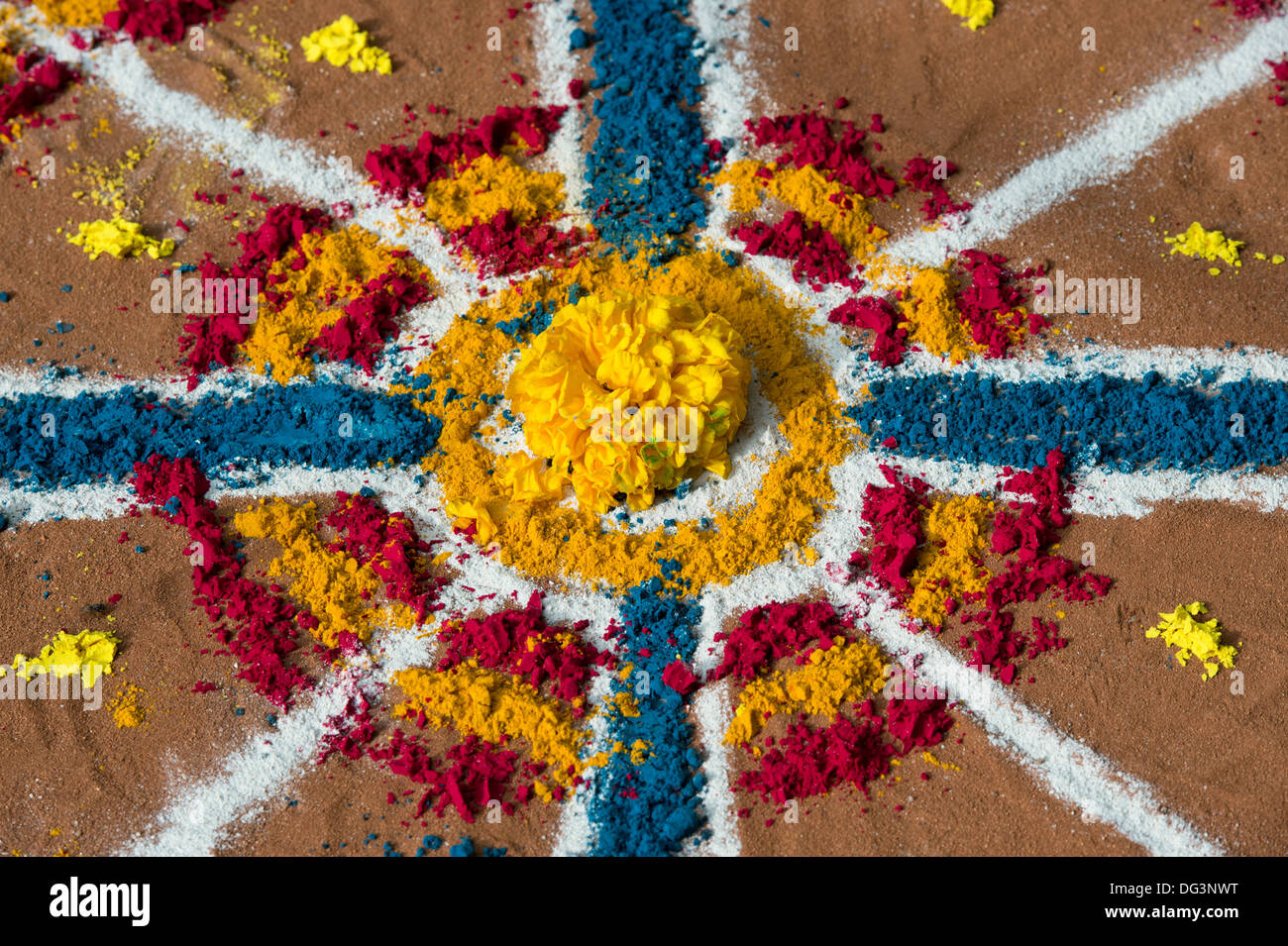 Dasara Rangoli festival coloured powder design and flowers in an Indian ...