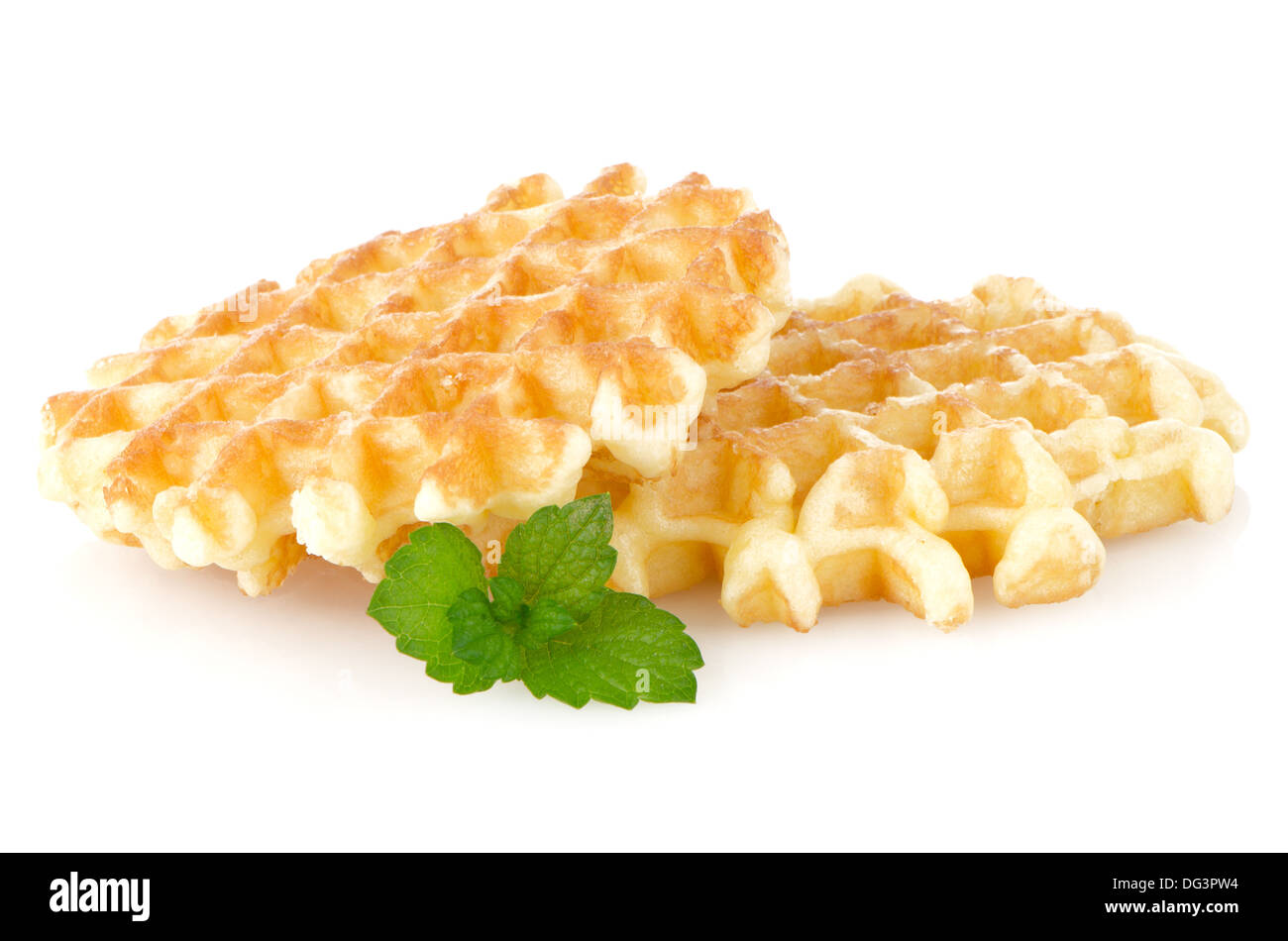 Pile of sweet waffles with green mint leaves isolated on white ...