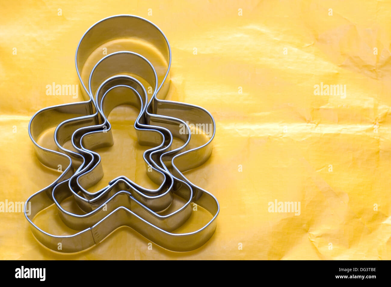 Gingerbread family cutters on orange background Stock Photo - Alamy