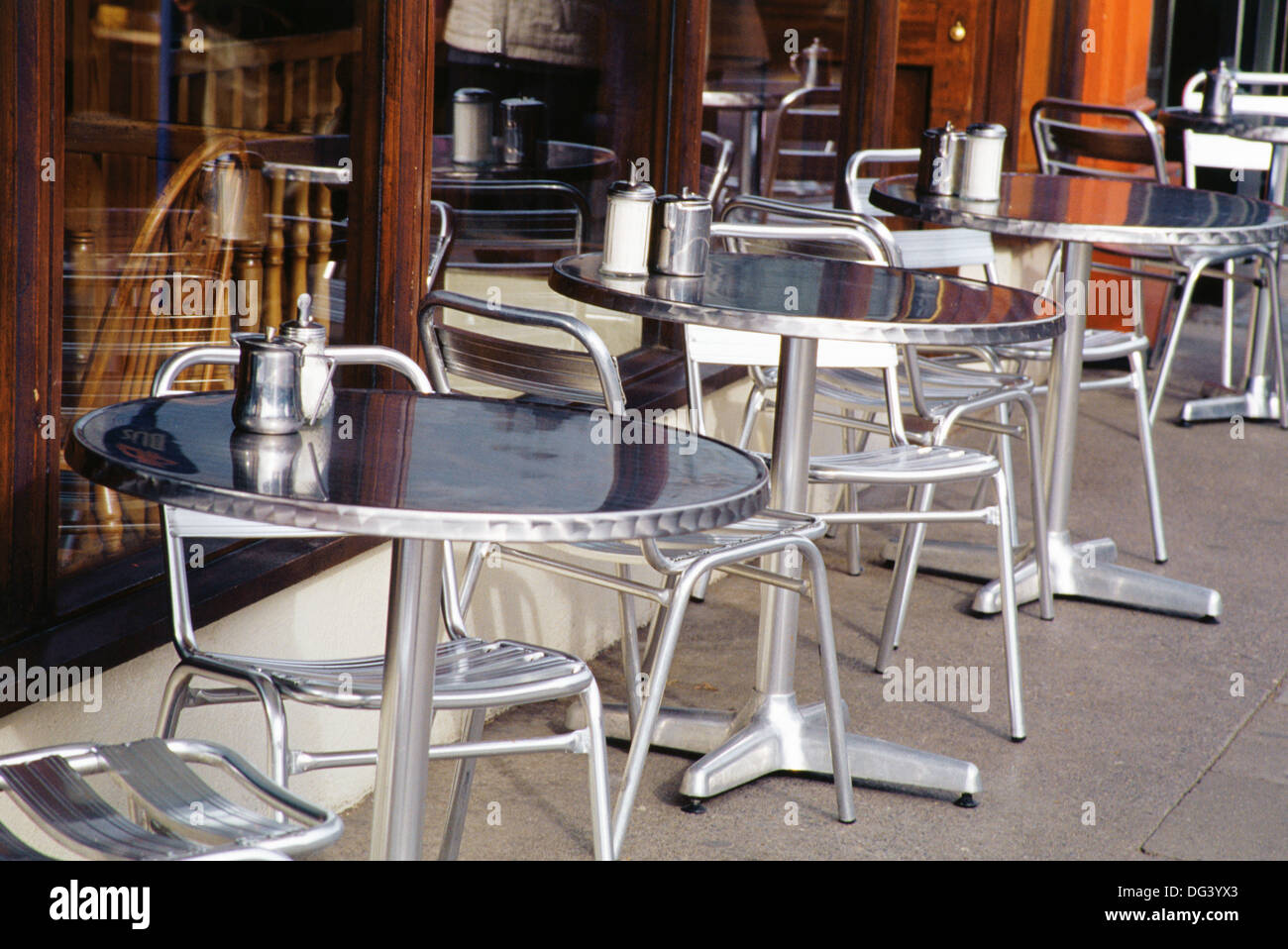 Tables on footpath outside coffee shop Stock Photo - Alamy