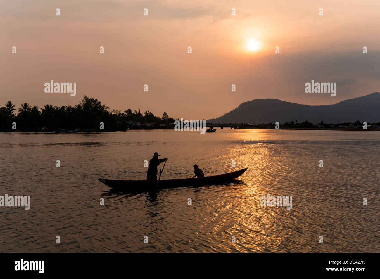 Father and son fishing on Kampong Bay River at sunset, Kampot, Cambodia ...