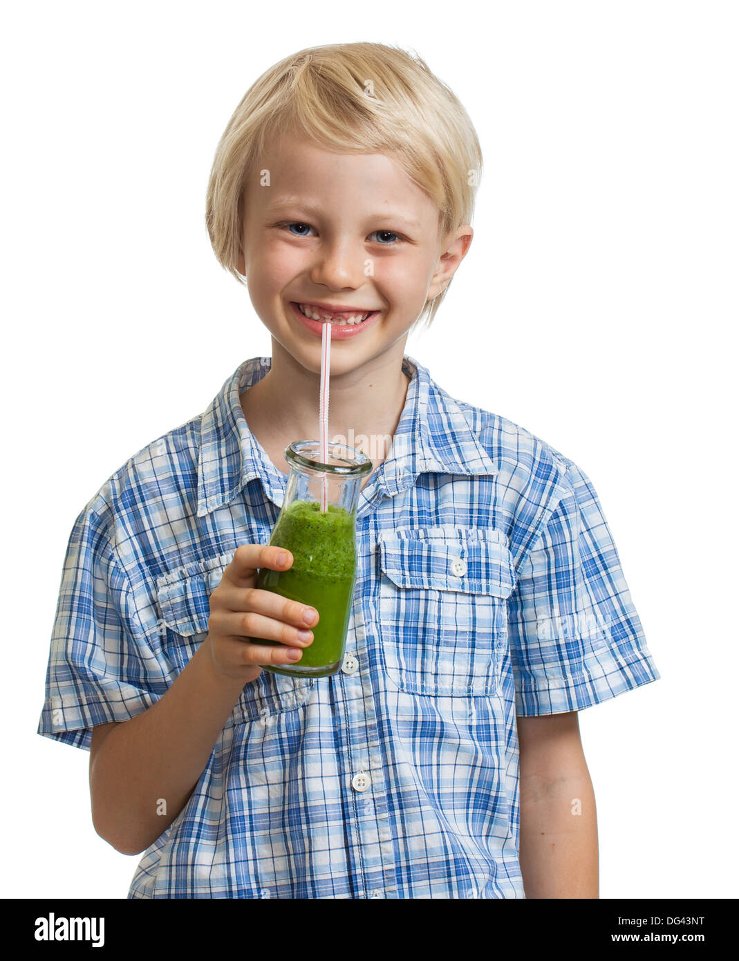 A cute young healthy boy drinking a green smoothie or jucie. Isolated ...