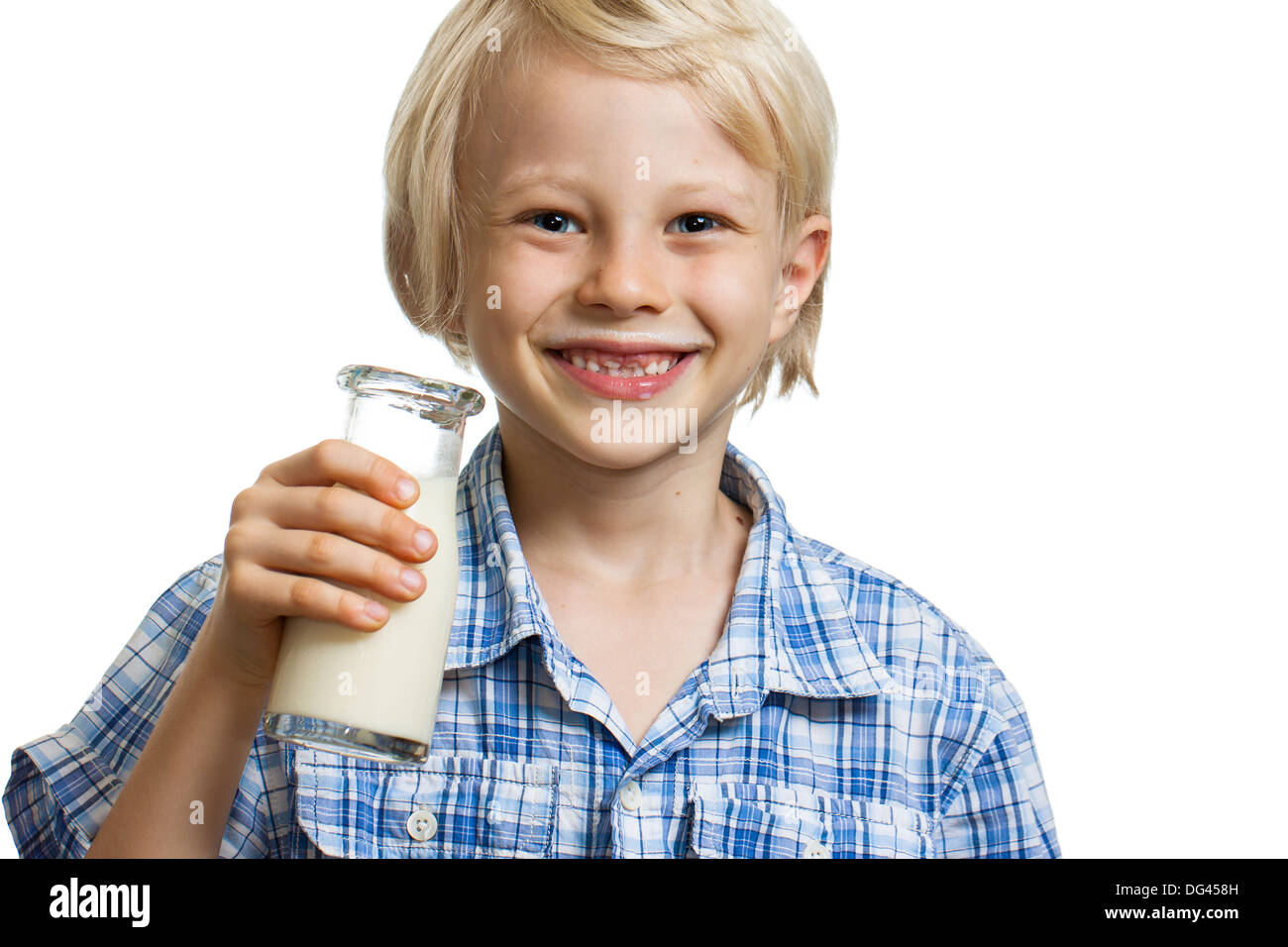 Close-up portrait of a happy cute boy with a bottle of milk and a milk ...