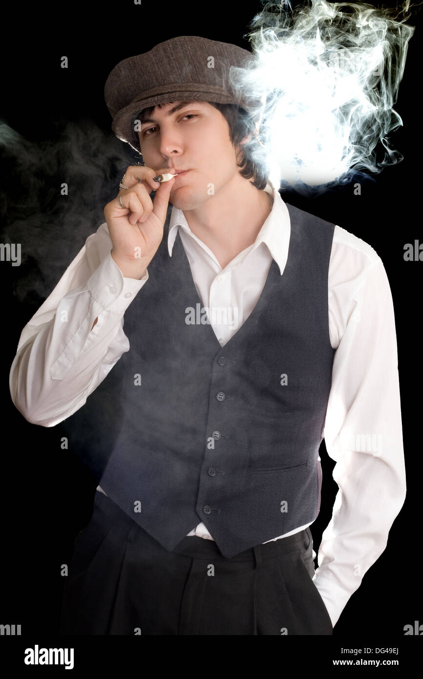Young man puffing out. Isolated on black Stock Photo - Alamy
