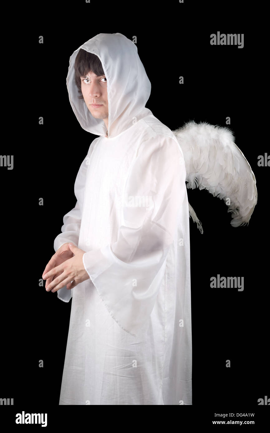 Young man wearing angel suit. Isolated on black Stock Photo - Alamy