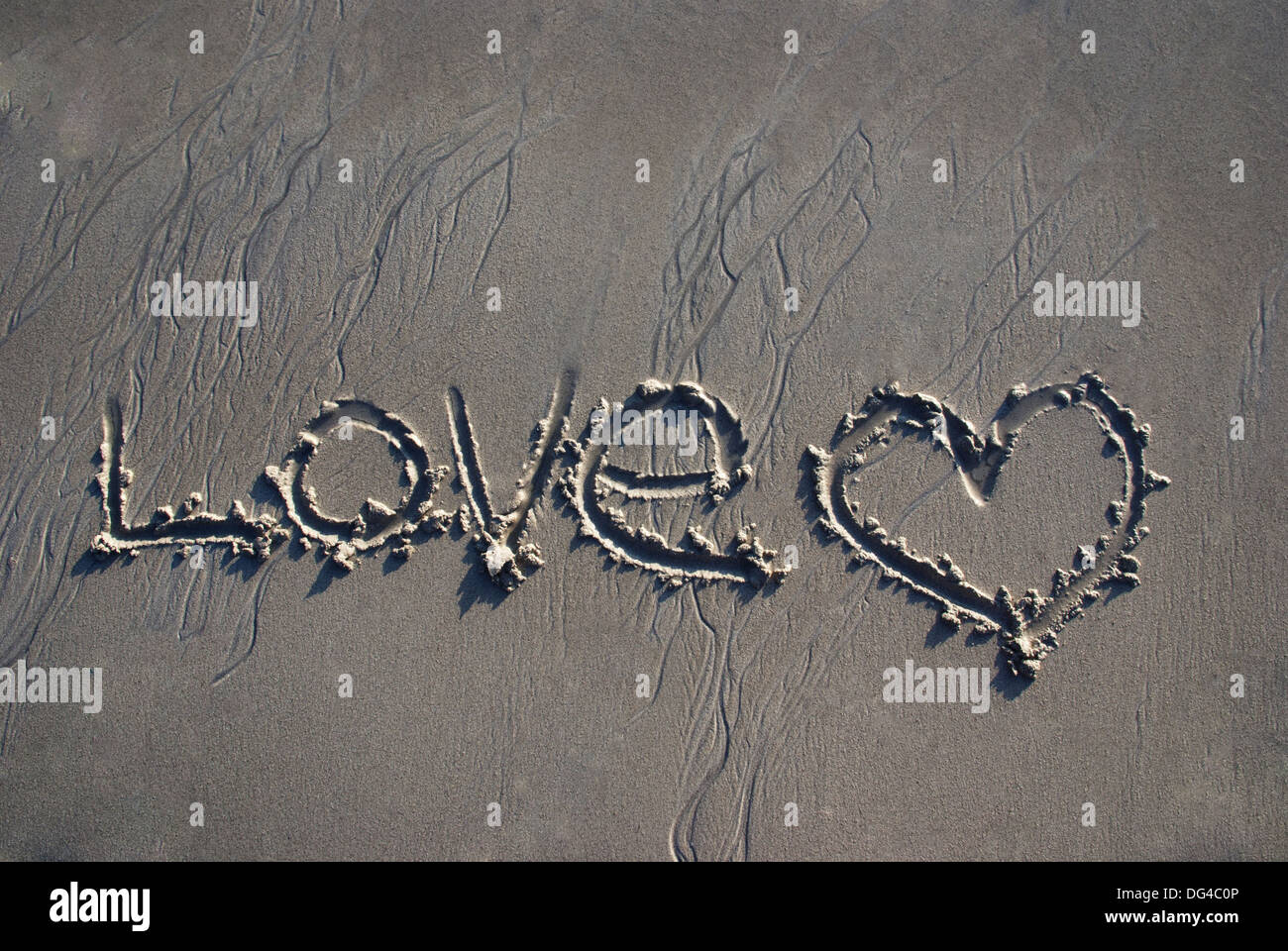 The Word Love With a Heart Written in Sand With Fading Lines in the ...