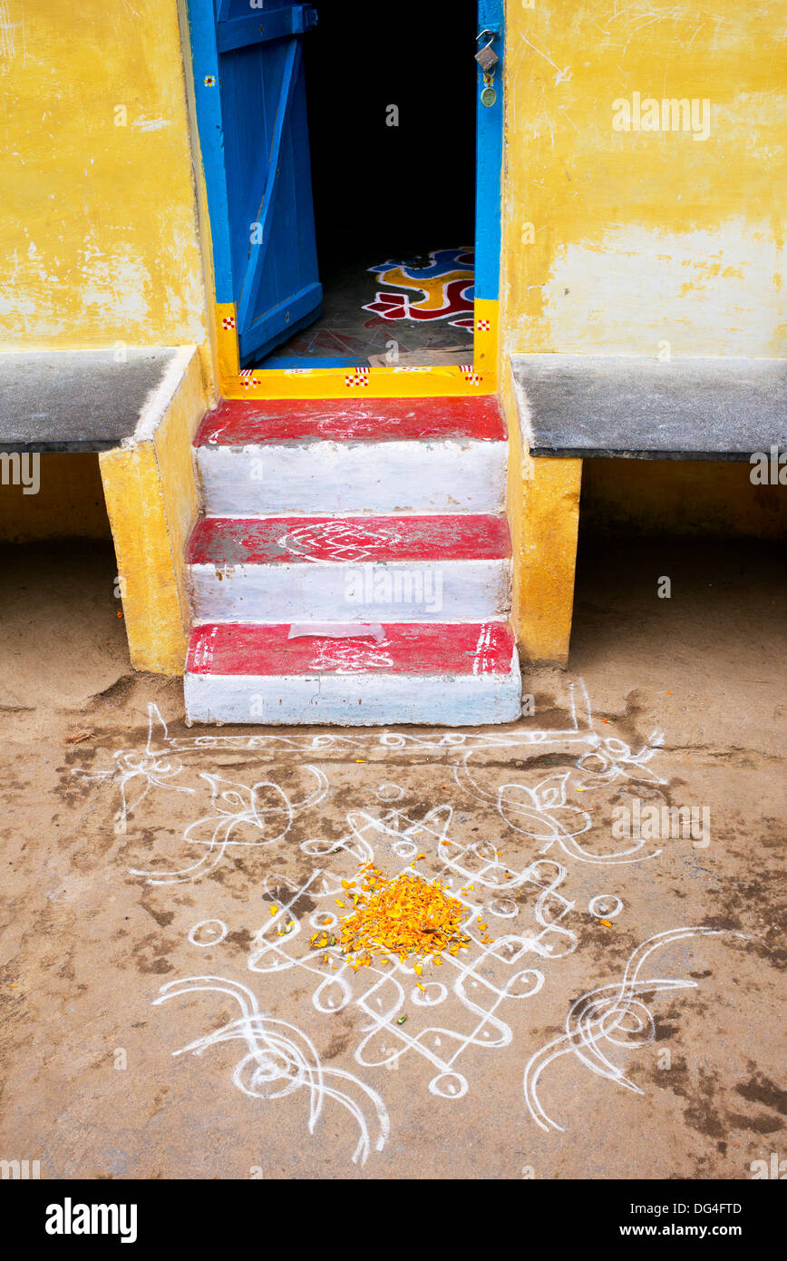 Simple Dasara Rangoli festival coloured powder design outside a rural ...