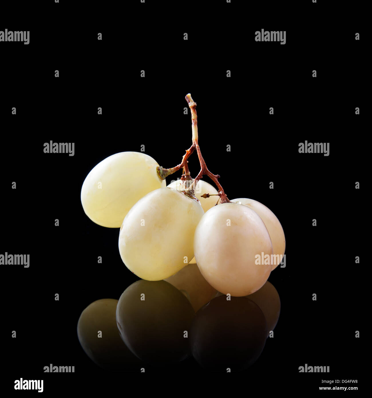 Small bunch of grapes on black background Stock Photo - Alamy