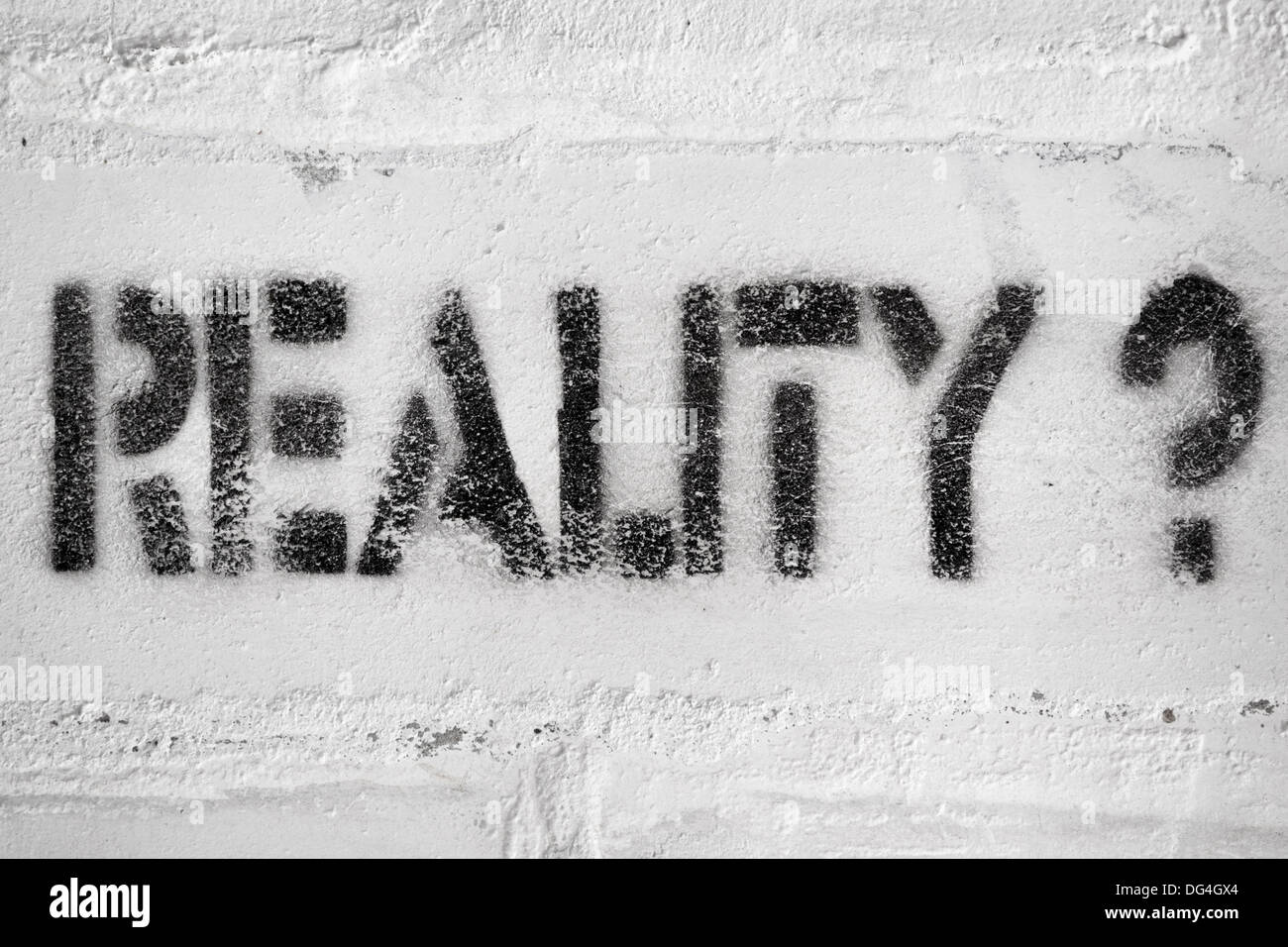 reality word with question mark handwritten on the white brick wall ...