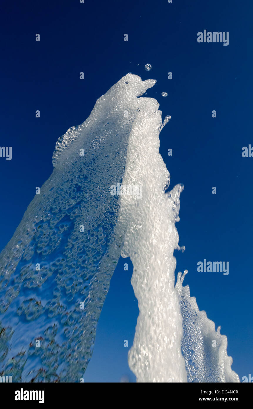 water jet of a fountain with blue sky Stock Photo - Alamy
