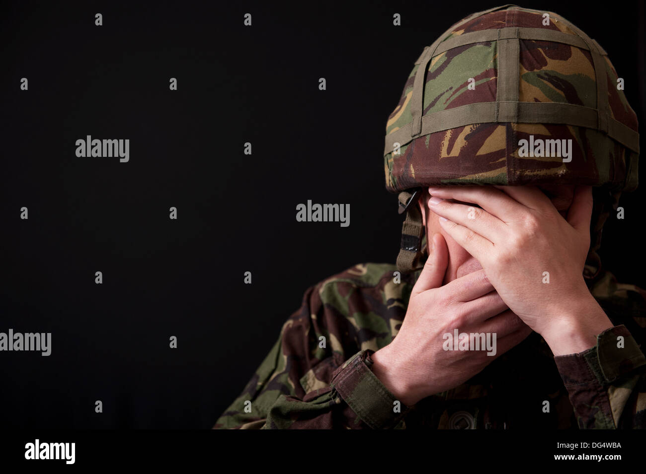 Soldier suffering with P.T.S.D./shell shock with his hand over his face ...