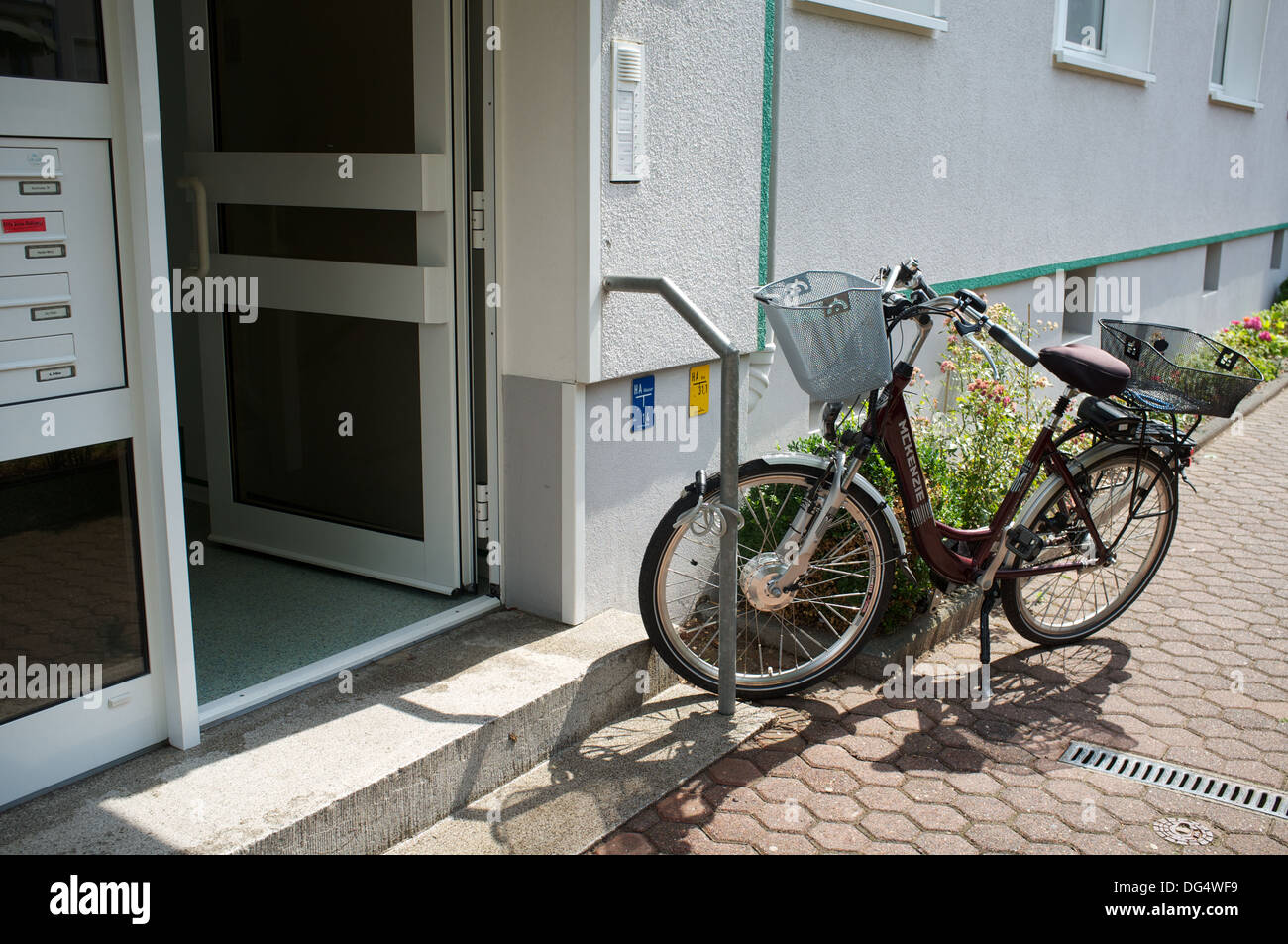 Electric bike parked outside apartment block Stock Photo - Alamy