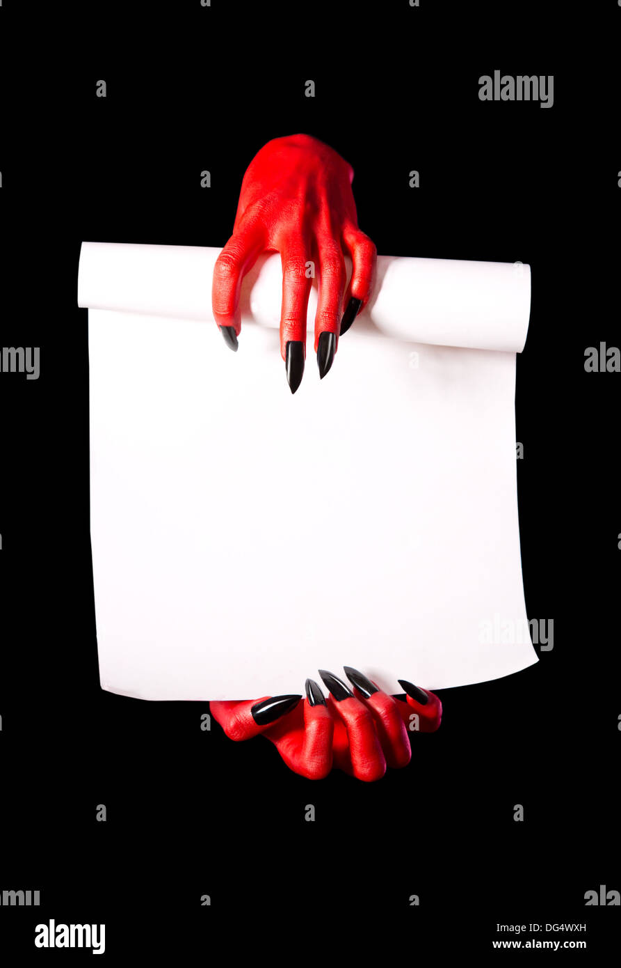 Red devil hands holding paper scroll for deal with devil concept ...