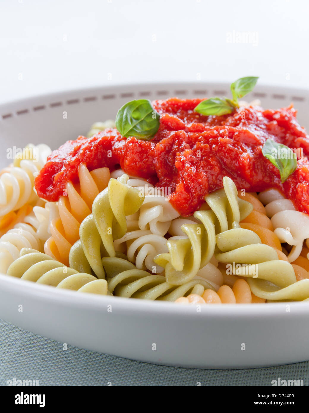 plate of fusilli with tomato sauce and basil Stock Photo - Alamy