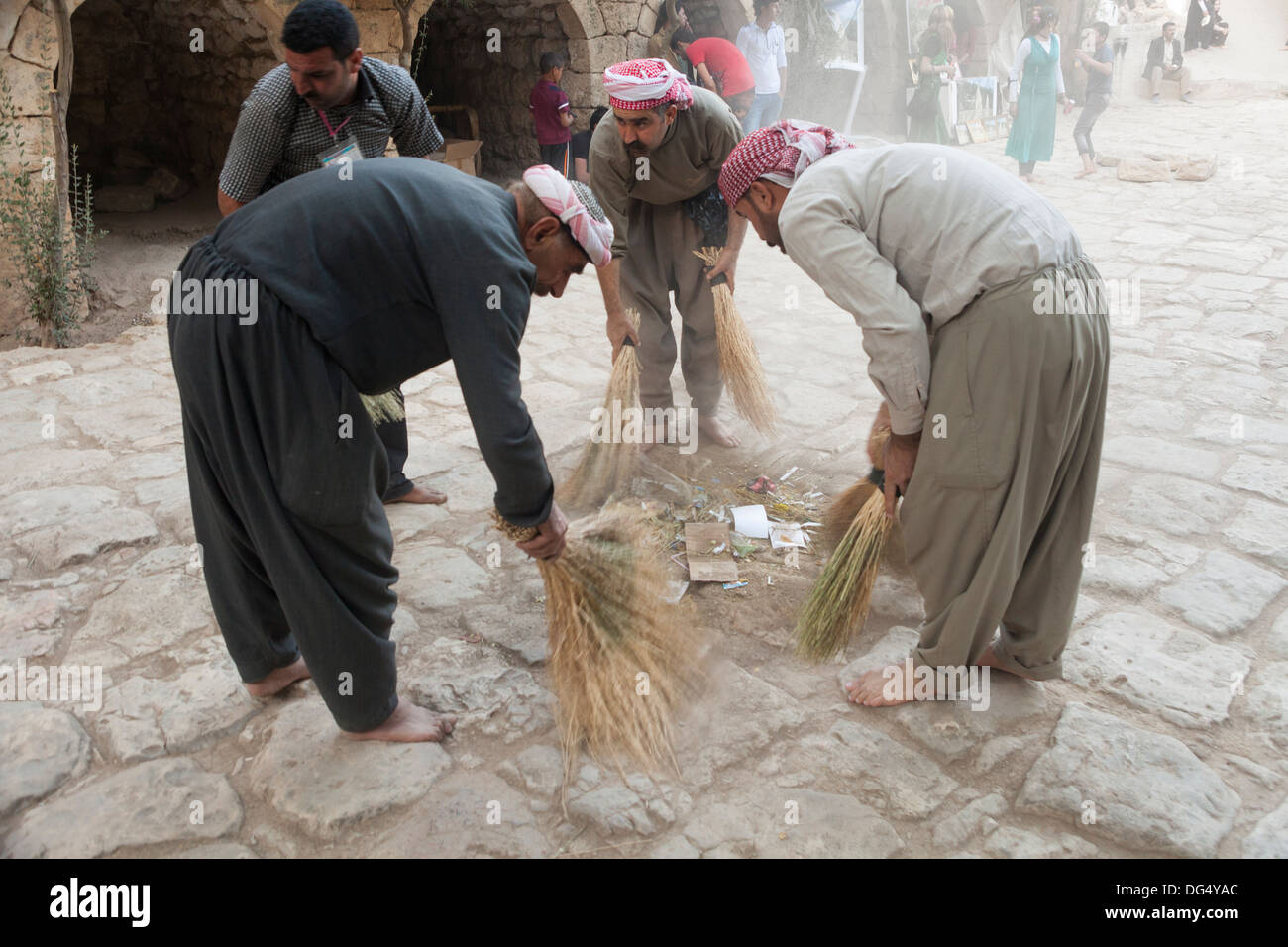 Lalish, Yazidi Holy city in North Iraq - cleaning man brushing the ...