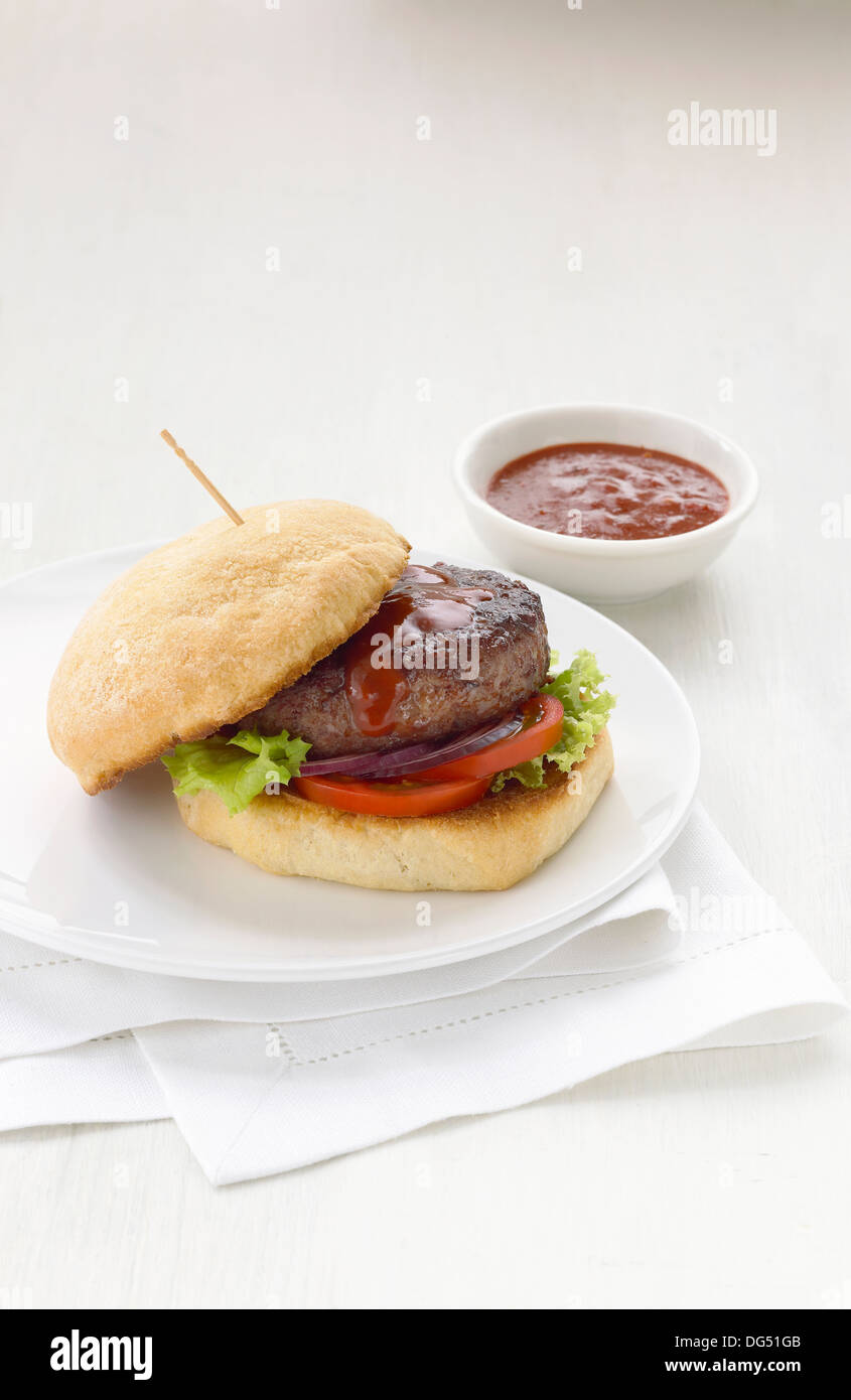 Juicy Beef Burger in a bap with salad & relish on the side Stock Photo ...