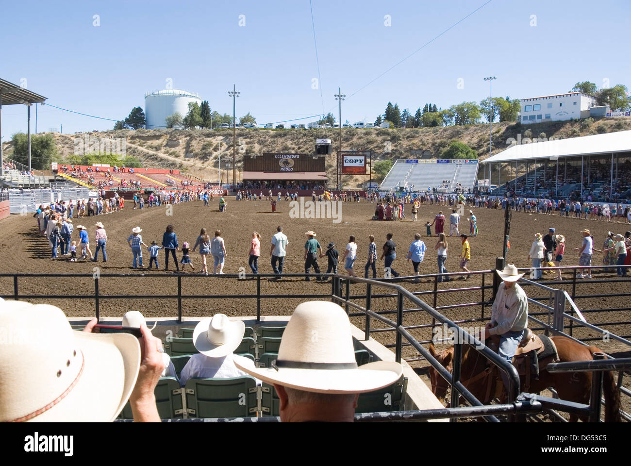 Indian tribespeople & rodeo spectators hold hands in a Friendship ...