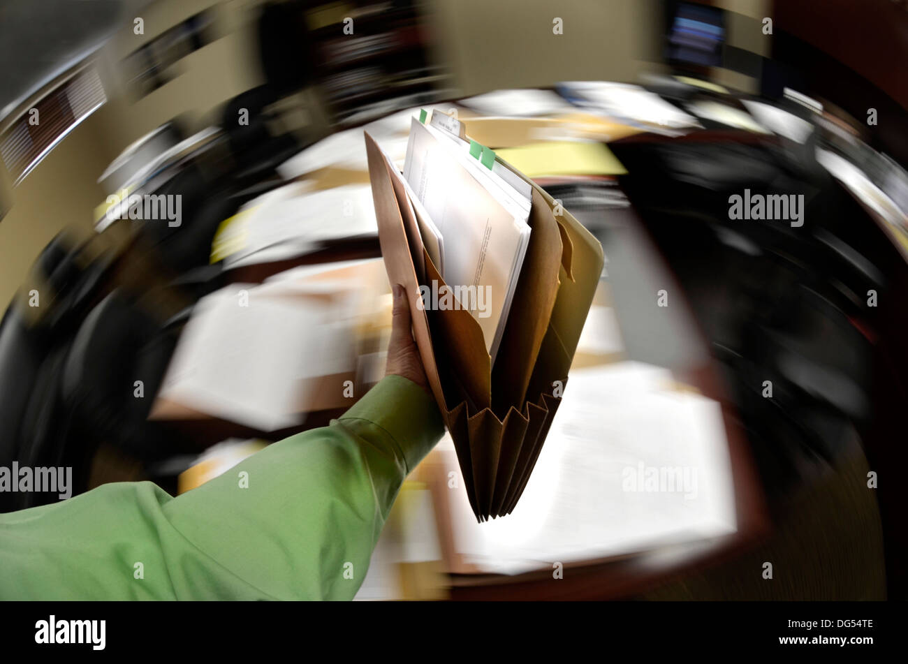 Holding file folder in office over desk Stock Photo - Alamy