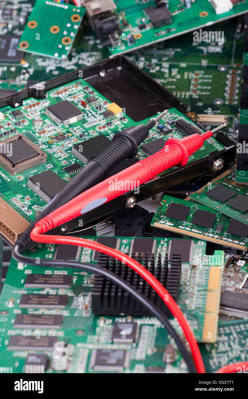 Measuring tips of a digital multimeter are on many circuit boards Stock ...