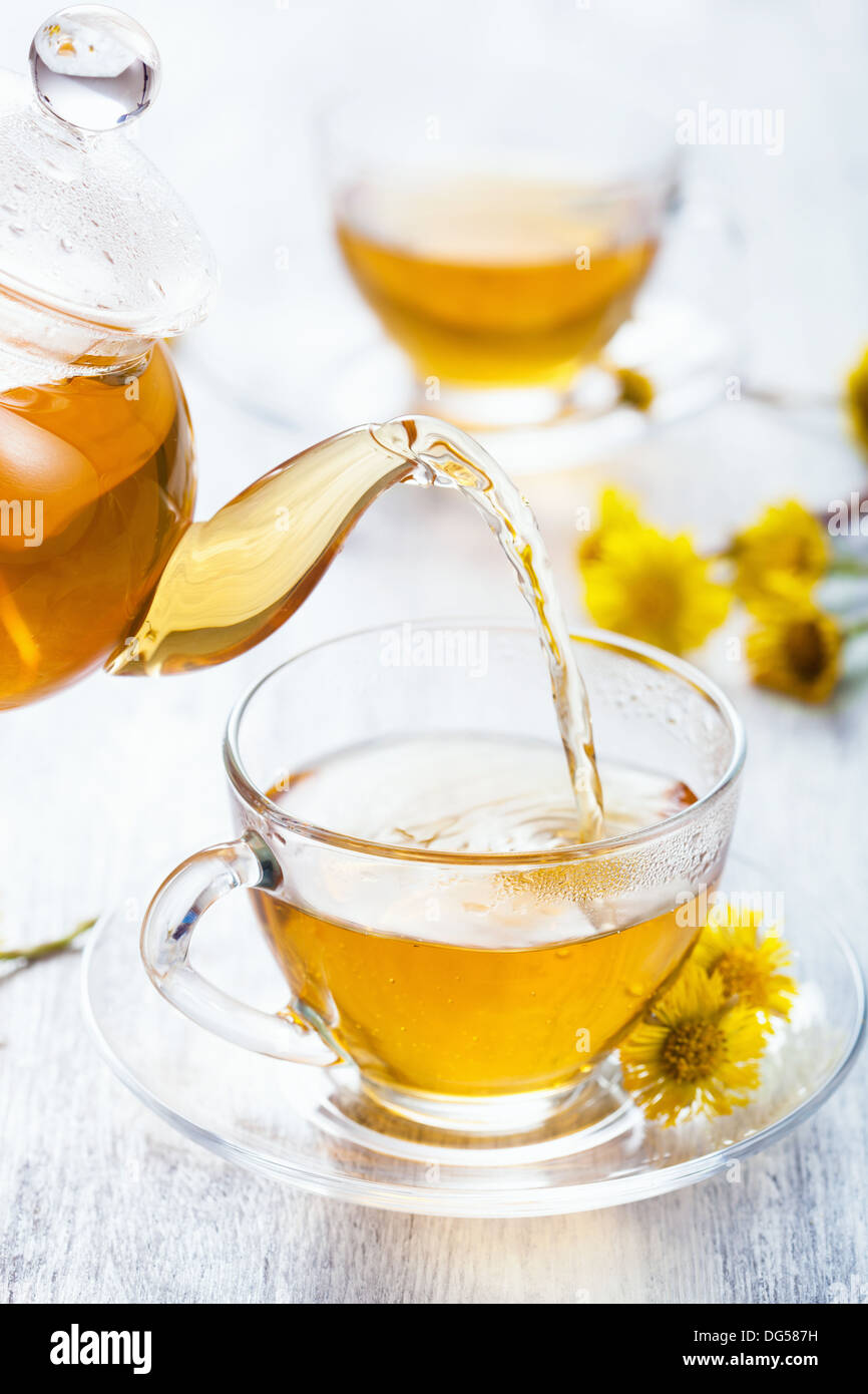 pouring herbal tea with coltsfoot flowers Stock Photo - Alamy