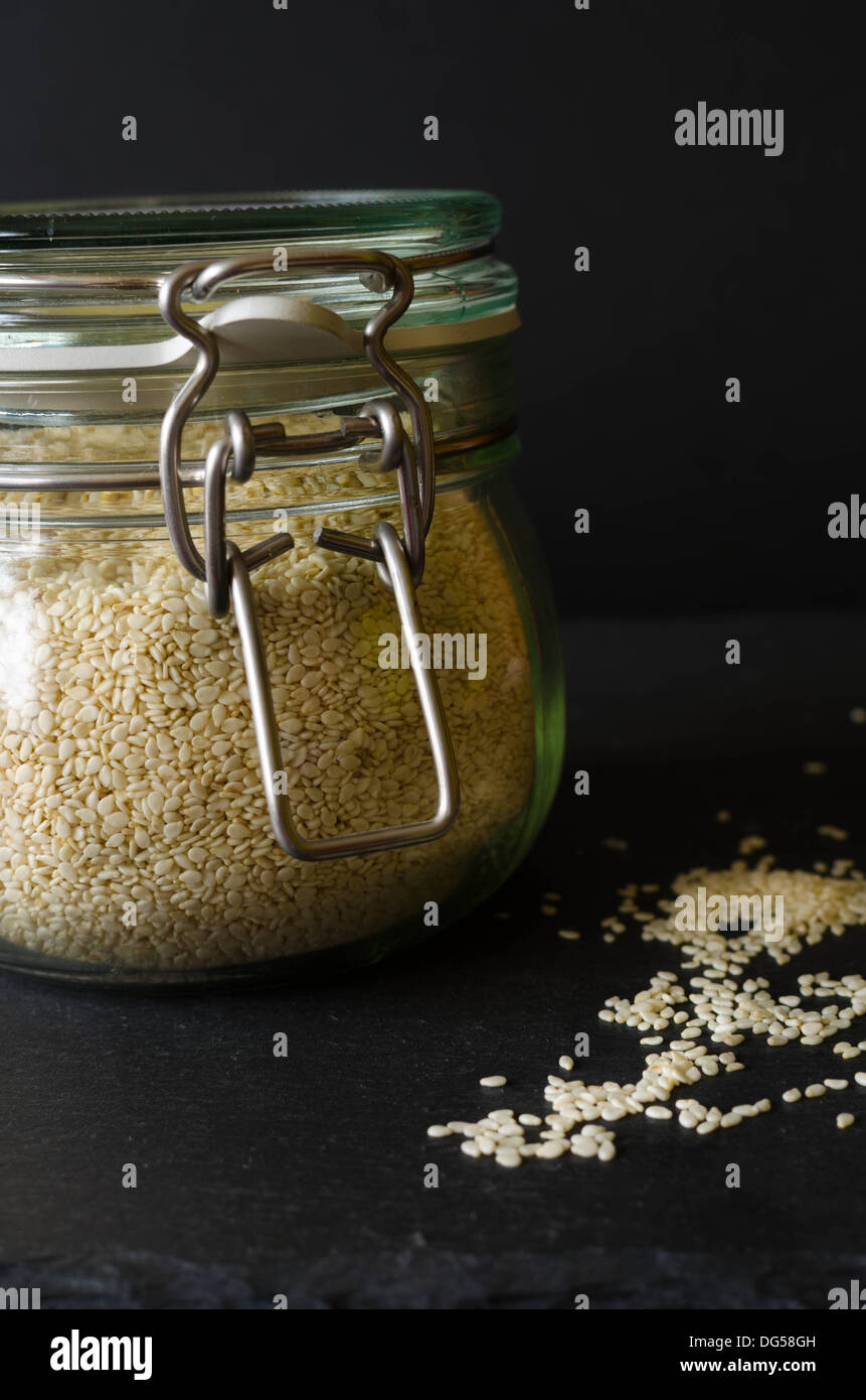 Sesame seed in a jar, black background Stock Photo - Alamy
