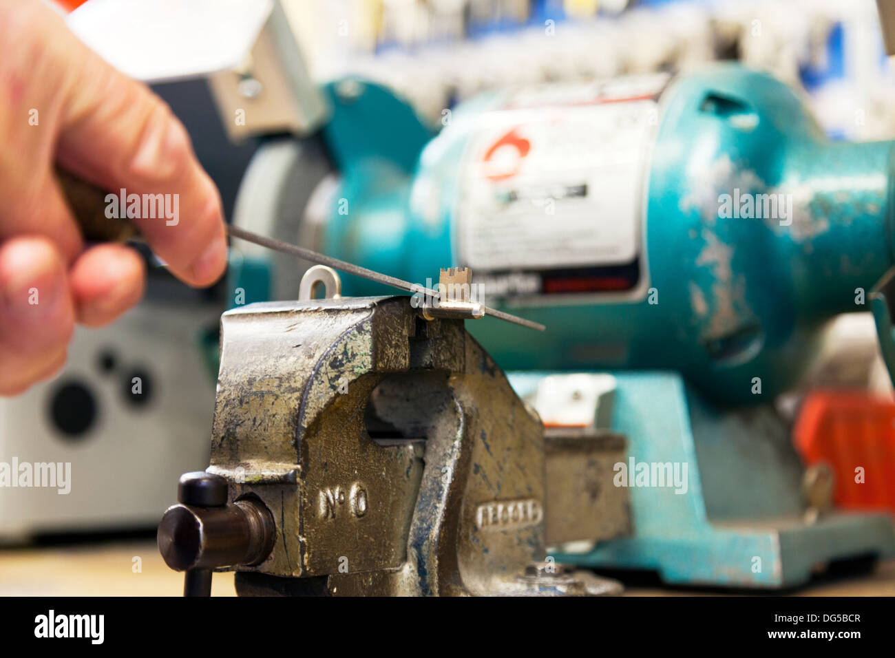 key cutter filing mortice key in vice cutting keys locksmith male mans ...