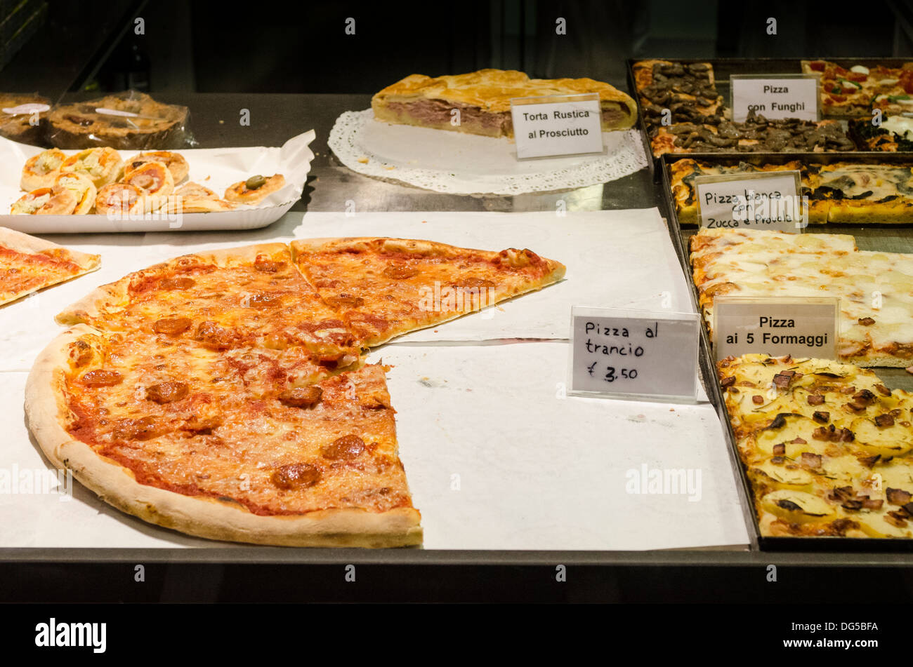 Sliced pizza in a window display in Italy Stock Photo - Alamy